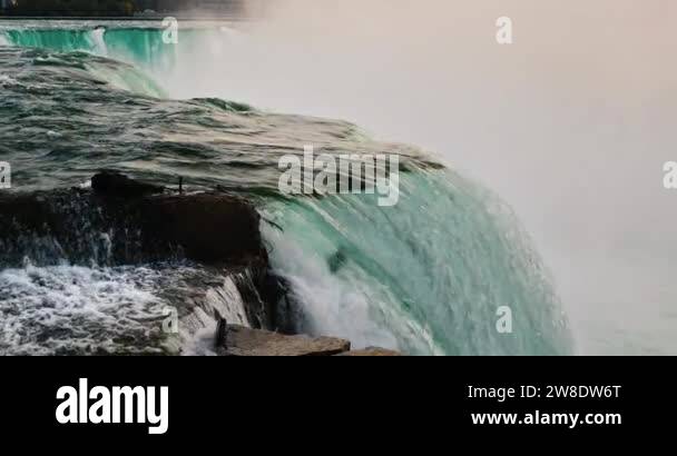 A mighty stream of water falls down - the majestic Niagara Falls, view ...