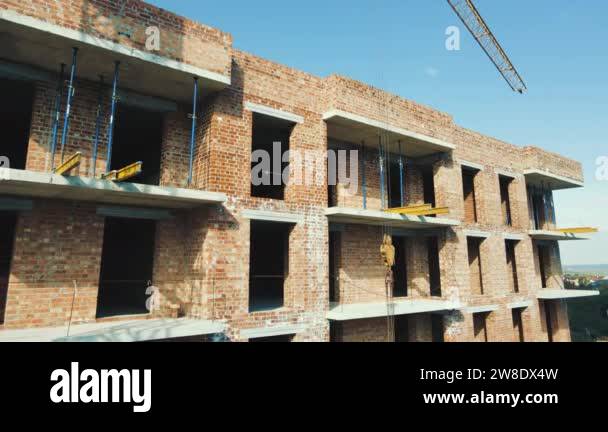 Construction of a multi-storey building. Brick house. Metal support ...