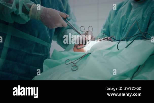 The doctor performs a pediatric surgical operation to remove the ...