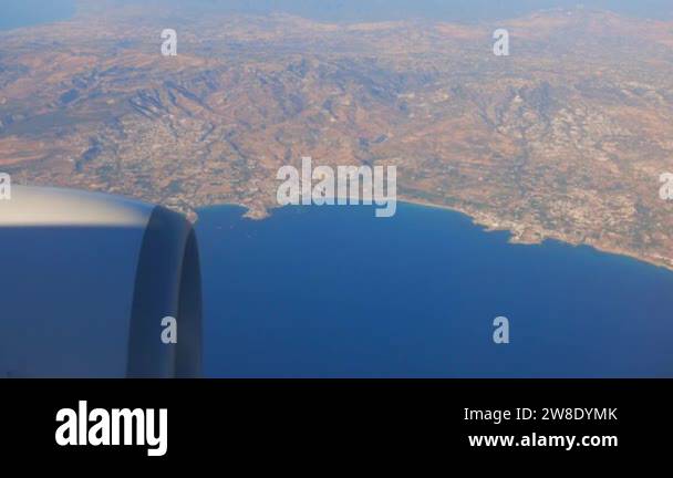 View from the plane window. Flying in an airplane over cities, lakes ...