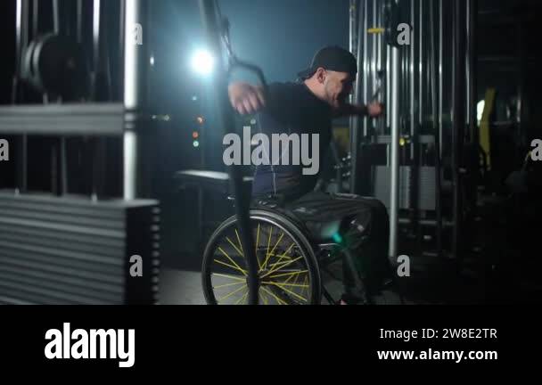 Fortitude, disabled athlete in wheelchair lifting blocks on rack ...