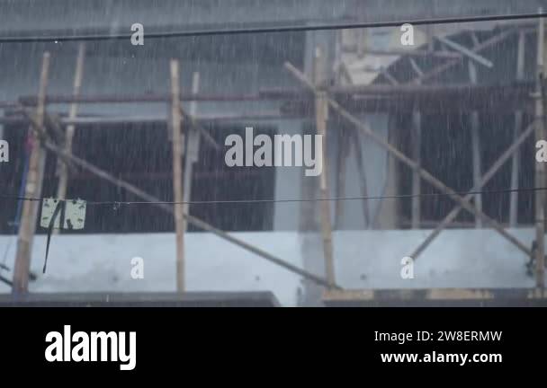 Close-up of black wires through which water drops flow against ...