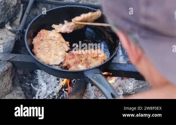 Man Cooking Fried Pork Chops in Oil in Frying Pan over Fire Outdoor ...
