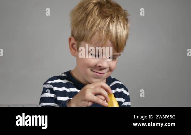 Happy Child Enjoys Eating Tasty Banana. Portrait Cute Little Boy. Glad ...