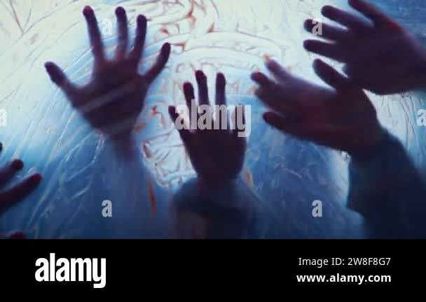 Monsters smearing blood over transparent film, trying to reach victim ...