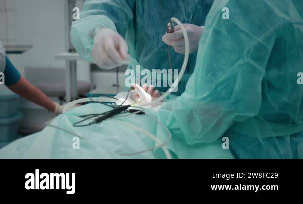 The doctor performs a pediatric surgical operation to remove the ...