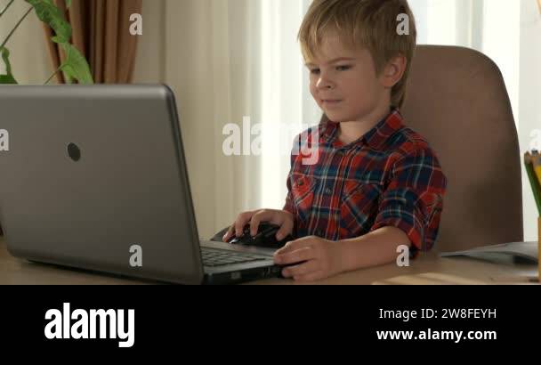 Clever Little Child Uses Laptop Computer for Study. Kid Distance ...