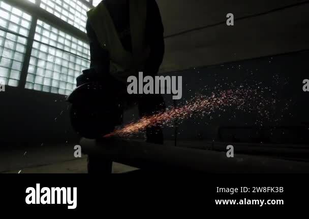 Construction worker cuts steel with a circular saw, construction ...