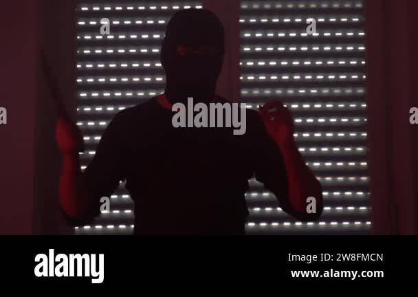 Dangerous killer in balaclava preparing for struggle with enemy, serial ...