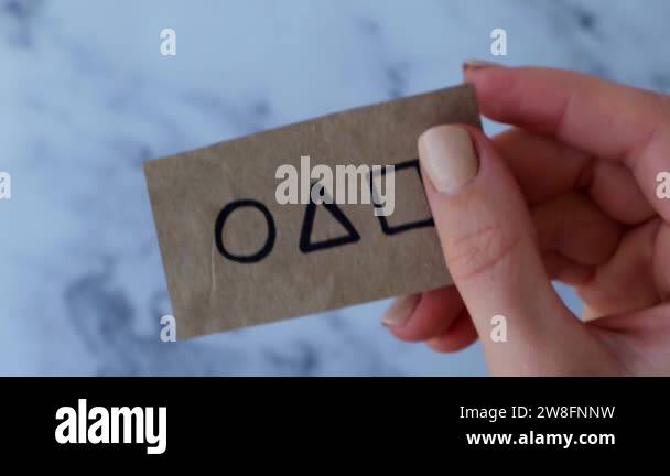 Kiev Ukraine - October 2021 Hand holding a squid game invitation card ...