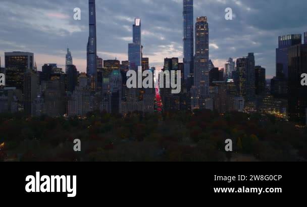 Amazing footage of evening downtown. Fly above trees in Central park ...