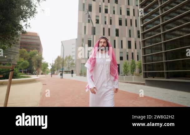 Successful arab man sheikh in traditional clothes looking at ...