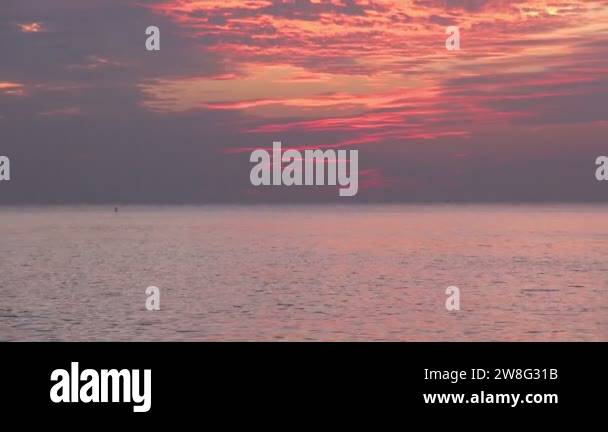 Sunset of sun setting over pacific ocean on windy evening Stock Video ...