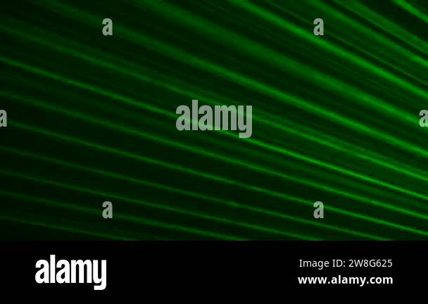 Bright beams of green neon laser light flashes and emitting lights in a ...