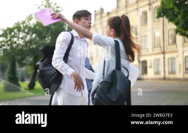 Handsome Caucasian boyfriend meeting girlfriend at university campus ...