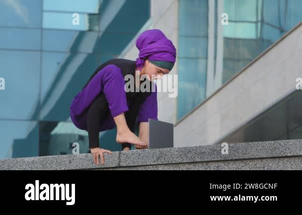 Young strong business woman islamic muslim student stands in balance ...