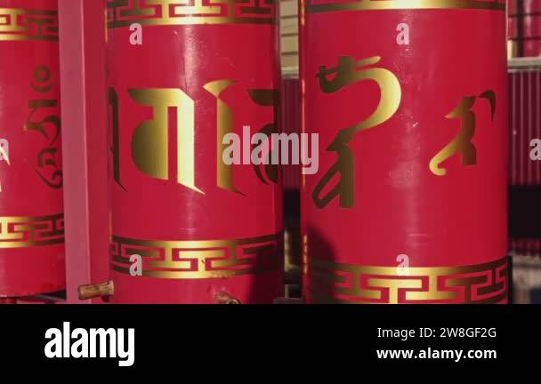 Beautiful Tibetan prayer wheels of red color. Tibetan buddhist praying ...