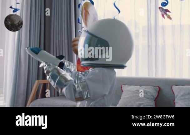 Creative spacewalk dreamer. Fantasy child astronaut flying in spaceship ...