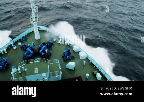 Sea storm waves break on the bow of the ship. Coast Guard during a storm in the ocean Stock ...