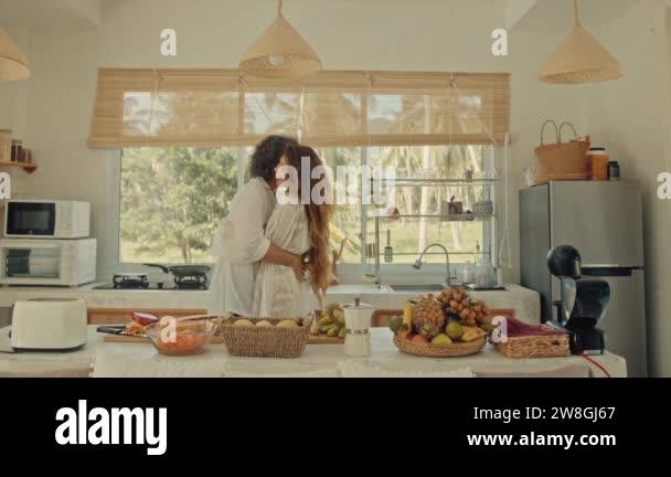 Young happy active married couple dancing laughing together cooking ...