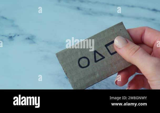 Kiev Ukraine - October 2021 Hand holding a squid game invitation card ...