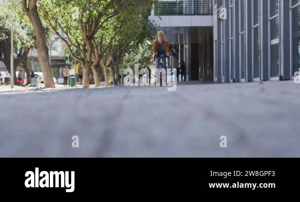 Albino african american man with dreadlocks riding bike on street. on ...