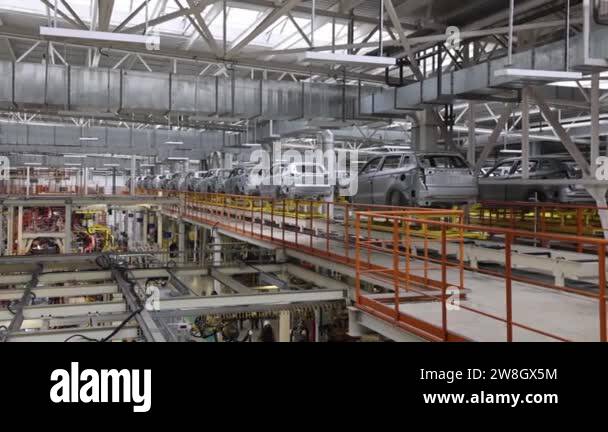 movement of car bodies on a conveyor belt in a paint shop, cast ...