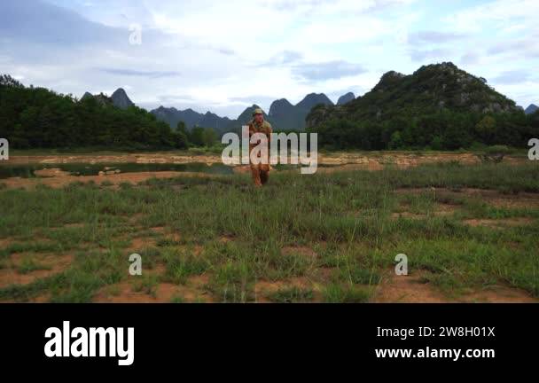 Cautious weary soldier scanning for enemies. Dirty battle worn soldier ...