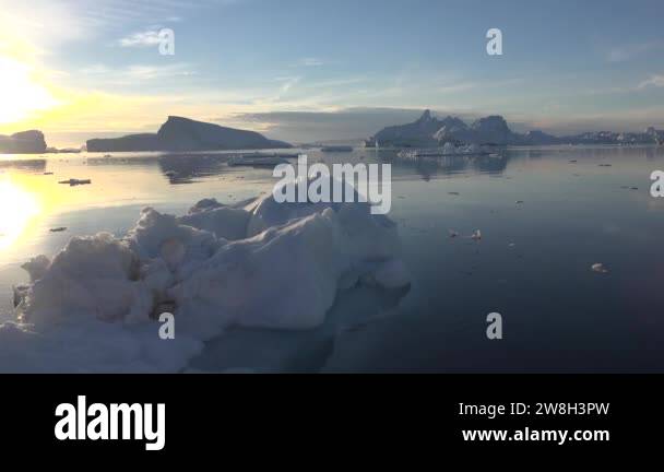 Floating glacial iceberg in frozen ocean water. Ecotourism and cruise travel to the Arctic and ...