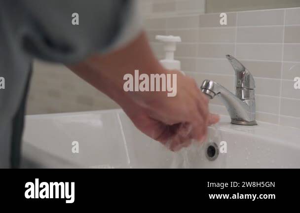 Men washing hands with soap and rubbing on hands around different areas ...