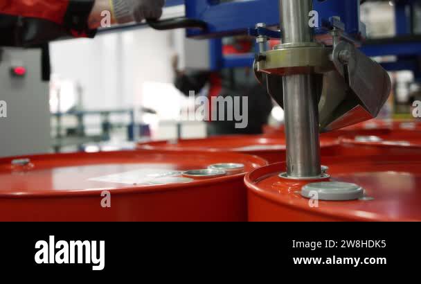 Machine oil production plant. Gray plastic bottles move along a ...
