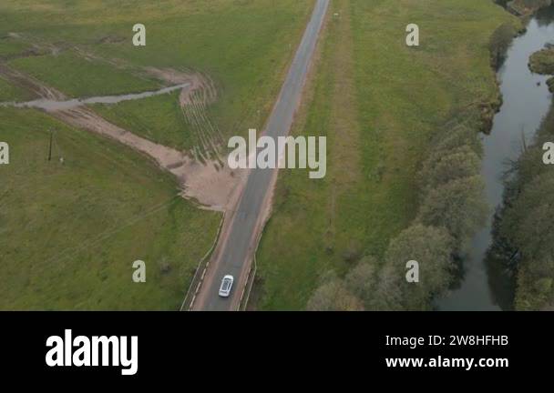 Aerial view of white electric car driving on countryside road. Modern ...