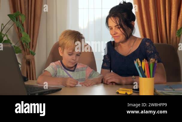 Young Mother Teach Child Help Study Homework. Little Boy Distance Learning at Home. Preschooler ...