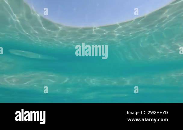 Beneath the surface view of the underwater sea with natural rays of light shining through the ...