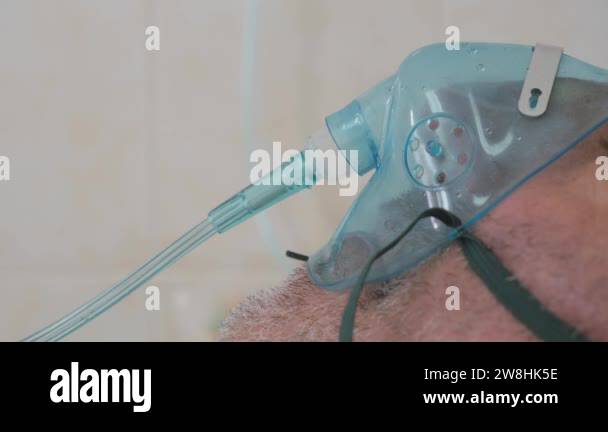 Unshaven part of the face of a man wearing an oxygen mask. Oxygen-rich ...