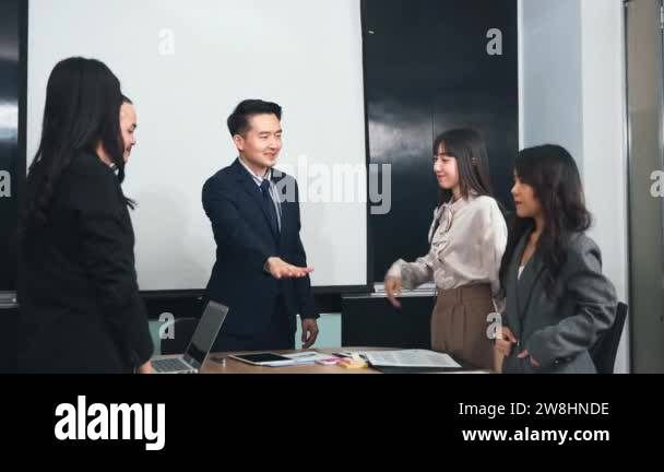 Business people join putting hands as team during their meeting, Stack of hands coming together ...
