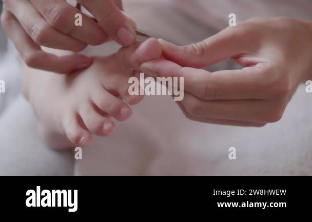 Mother cuts nails on her childs toes. Close-up photo of kids foot. Skin ...
