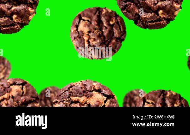 Flying Dark chocolate chip cookie of different diameters on the green ...