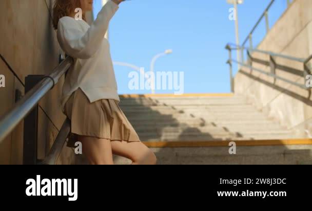 Model with long legs and dressed in mini are posing in slow motion in ...