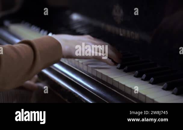 Female hands play the piano keys at the moment of intense action. Fast ...