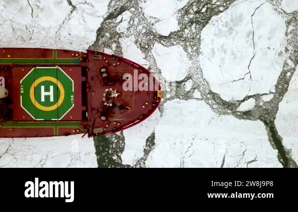 Drone top down Epic red steel icebreaker ship tanker breaks winter ...