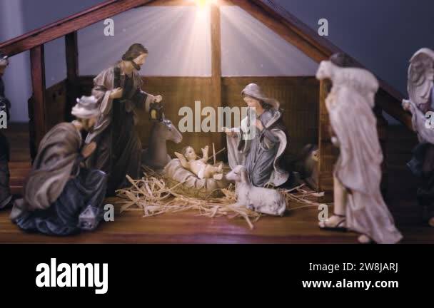 Jesus Christ Nativity scene with figurines in stable and light ...
