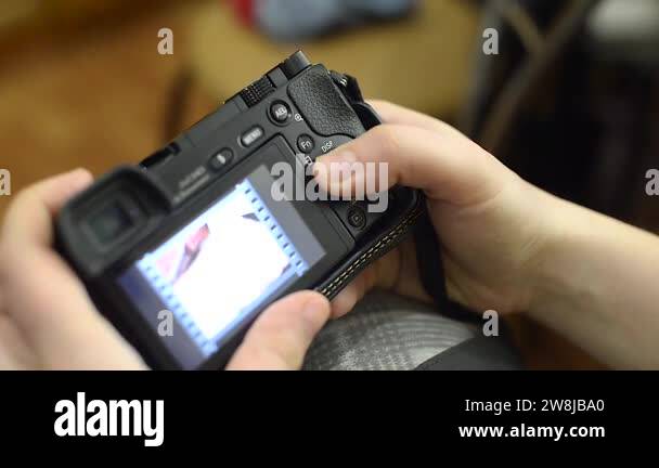 She sets up the camera before shooting. Man turns the wheels of the ...