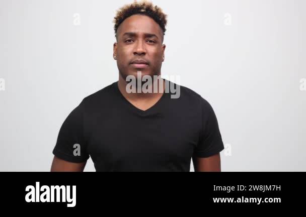 Rude black man shows his middle finger on an isolated white background ...