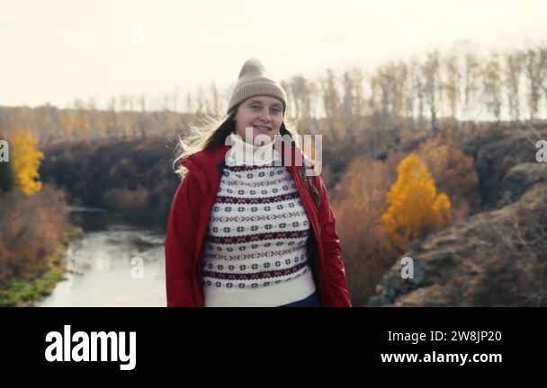 Caucasian woman in smiles and braces are visible on her teeth. She ...