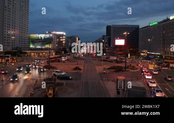 Evening traffic in city centre. Cars driving through large roundabout ...