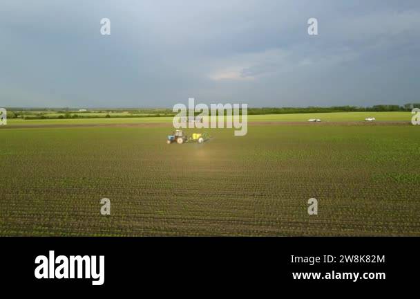 Tractor with movable sprinkler system and irrigation machine is ...