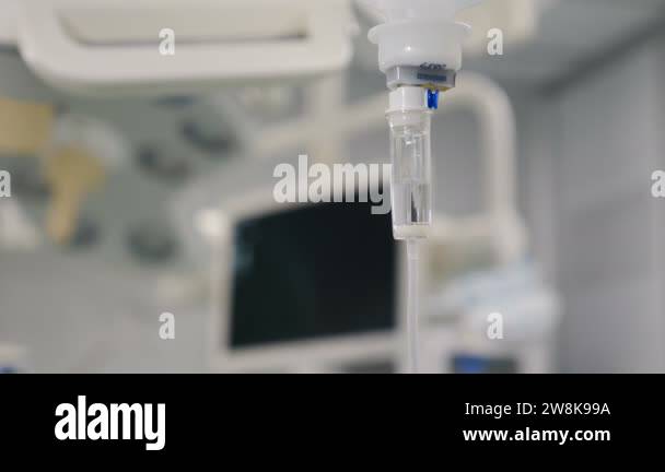 Intravenous drip in focus,surgeons team performing operation, infusion ...