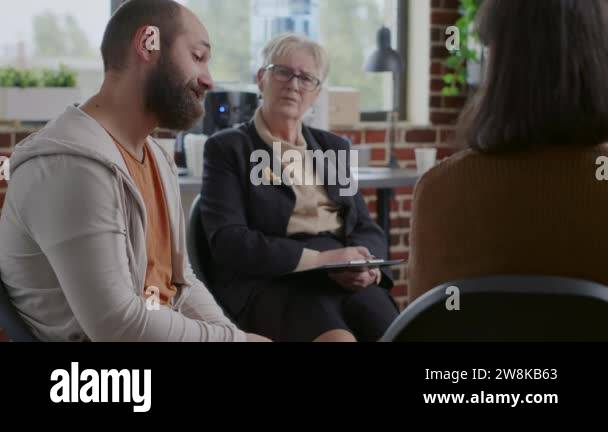 Man in despair sharing sad story about alcohol addiction in front of ...