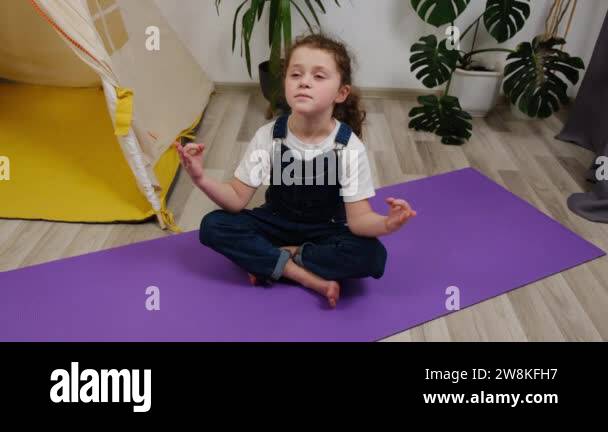Close up of happy healthy kid daughter having fun doing yoga exercise ...